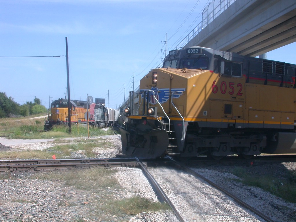 UP 6052 NB across the diamond while UP 3646 and UP 2730 are pushed back on the bypass waiting